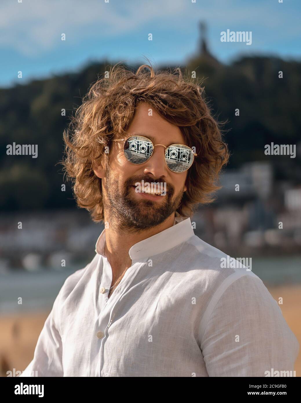Closeup shot of a laughing male model outside under the sun rays Stock ...