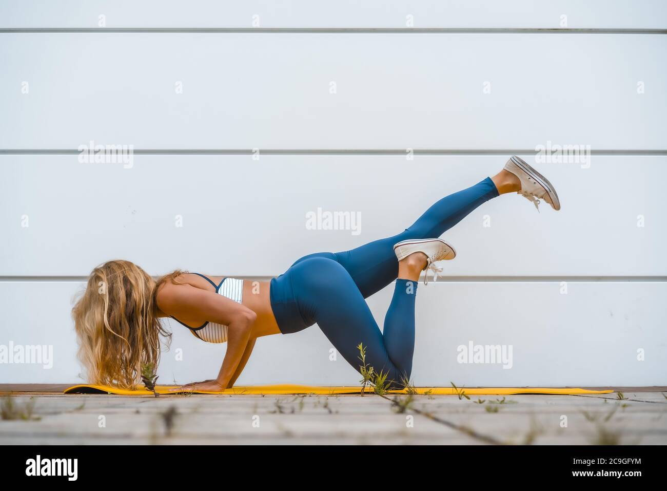 Flexible female model posing for yoga on white background Stock Photo ...