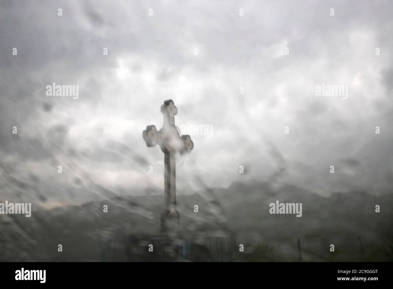 Dramatic religious photo of cross on a rainy day Stock Photo - Alamy