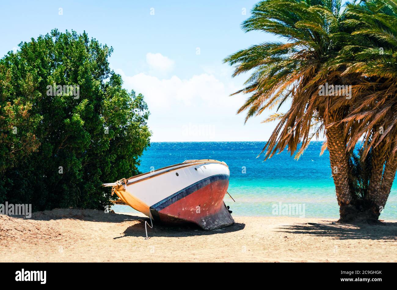 beach with old yacht and Red Sea palm tree resort Egypt without people ...