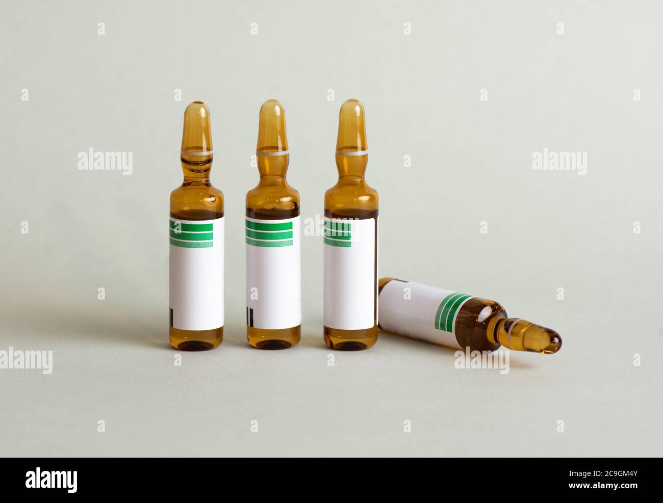 Closeup shot of four ampoules for injection with white labels on a ...