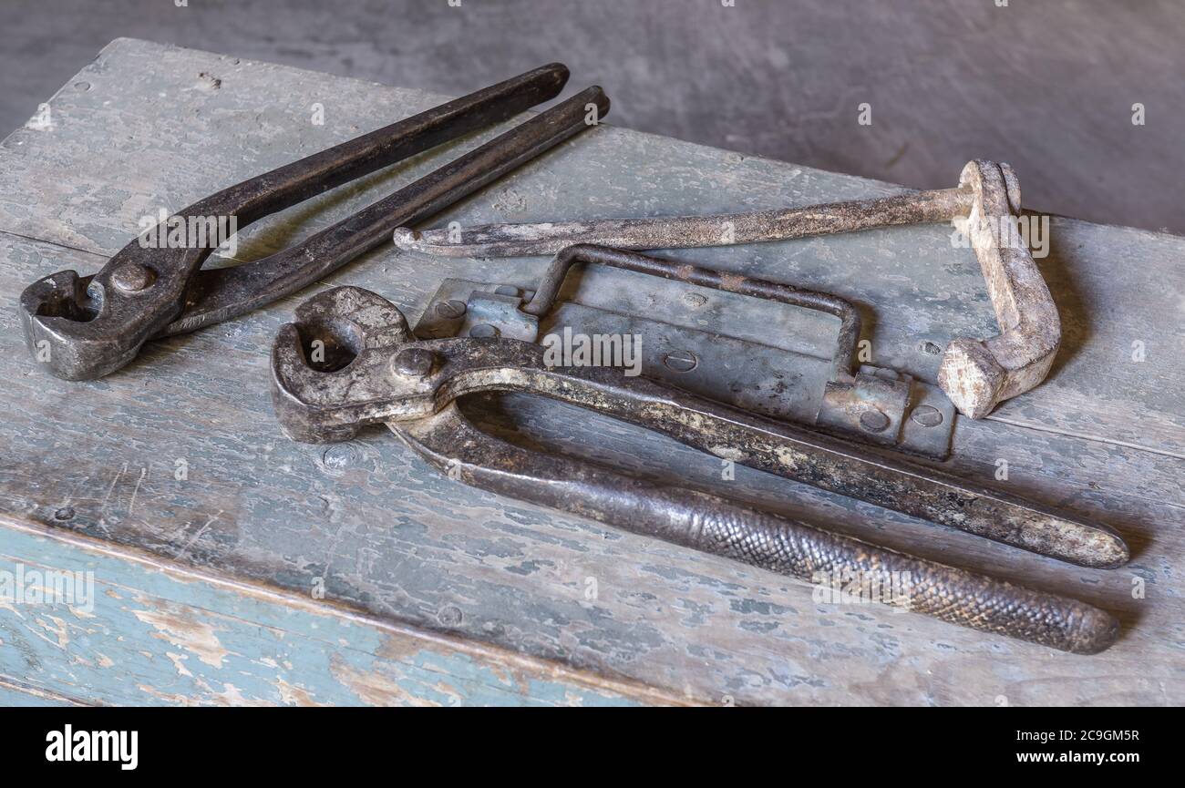 different types of pincers over old tools for housework, vintage look ...