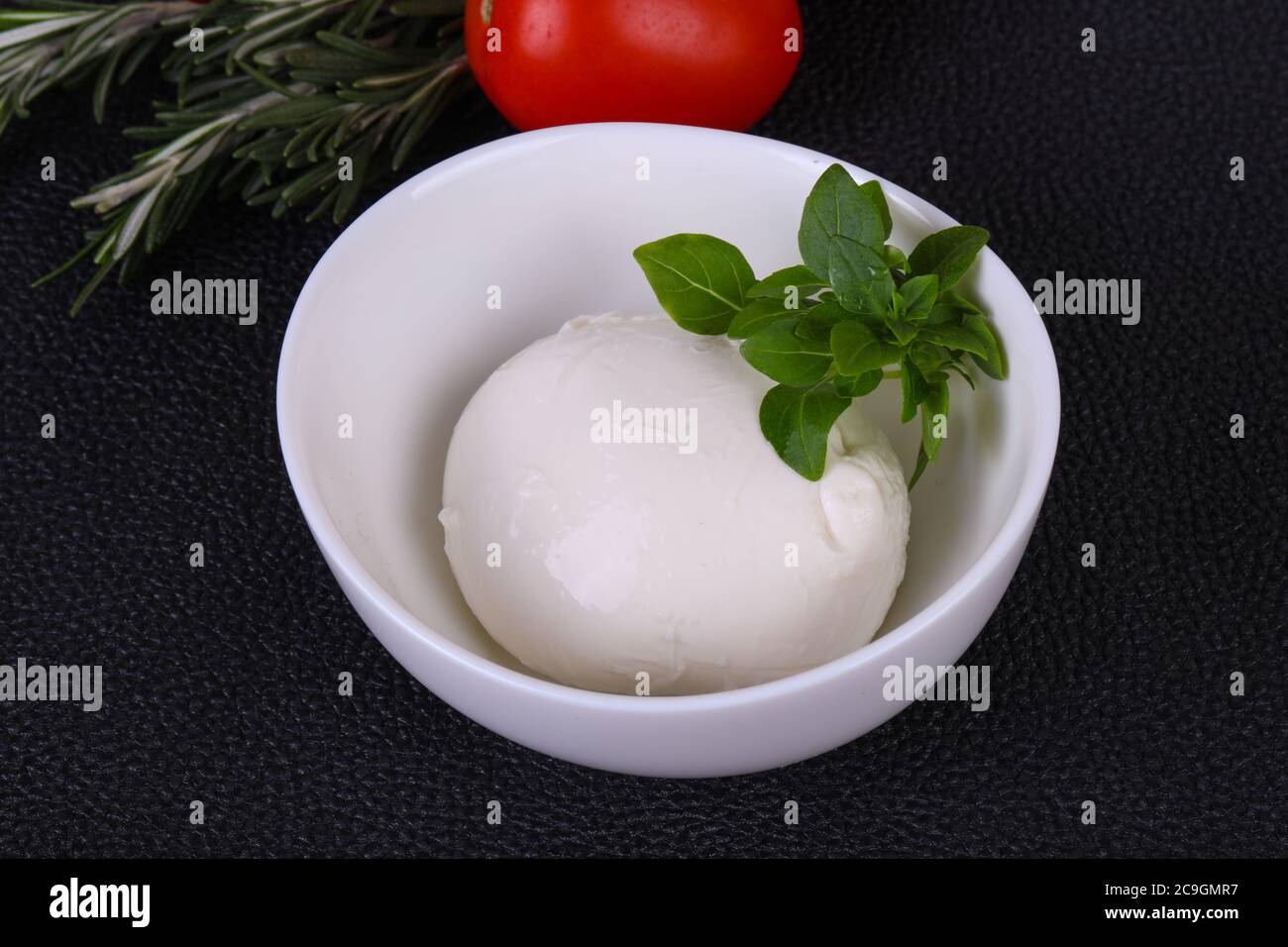 Italian Mozzarella cheese ball served basil and tomatoes Stock Photo ...