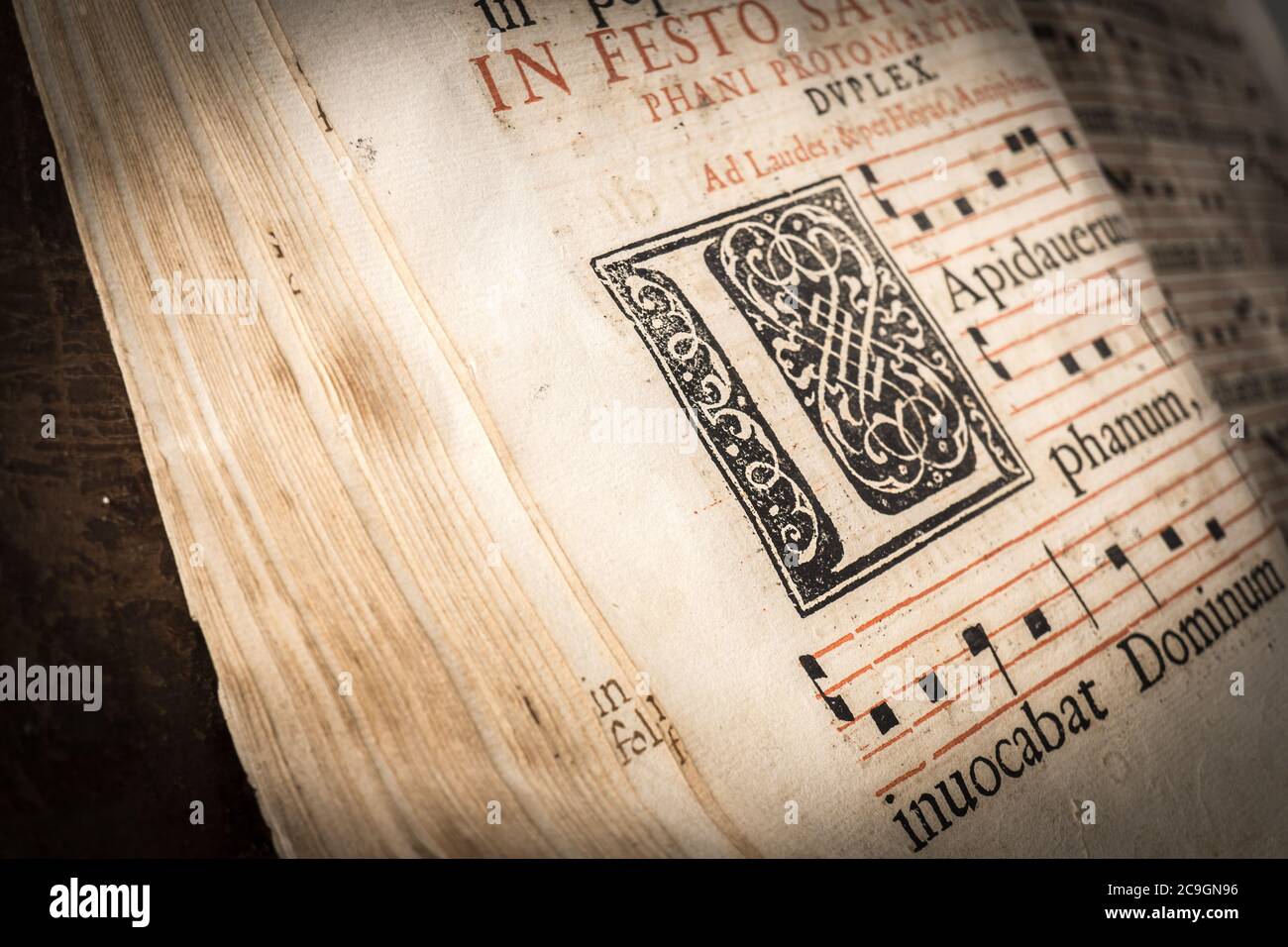 church choir books on a wooden lectern. detail of capital letter, macro ...