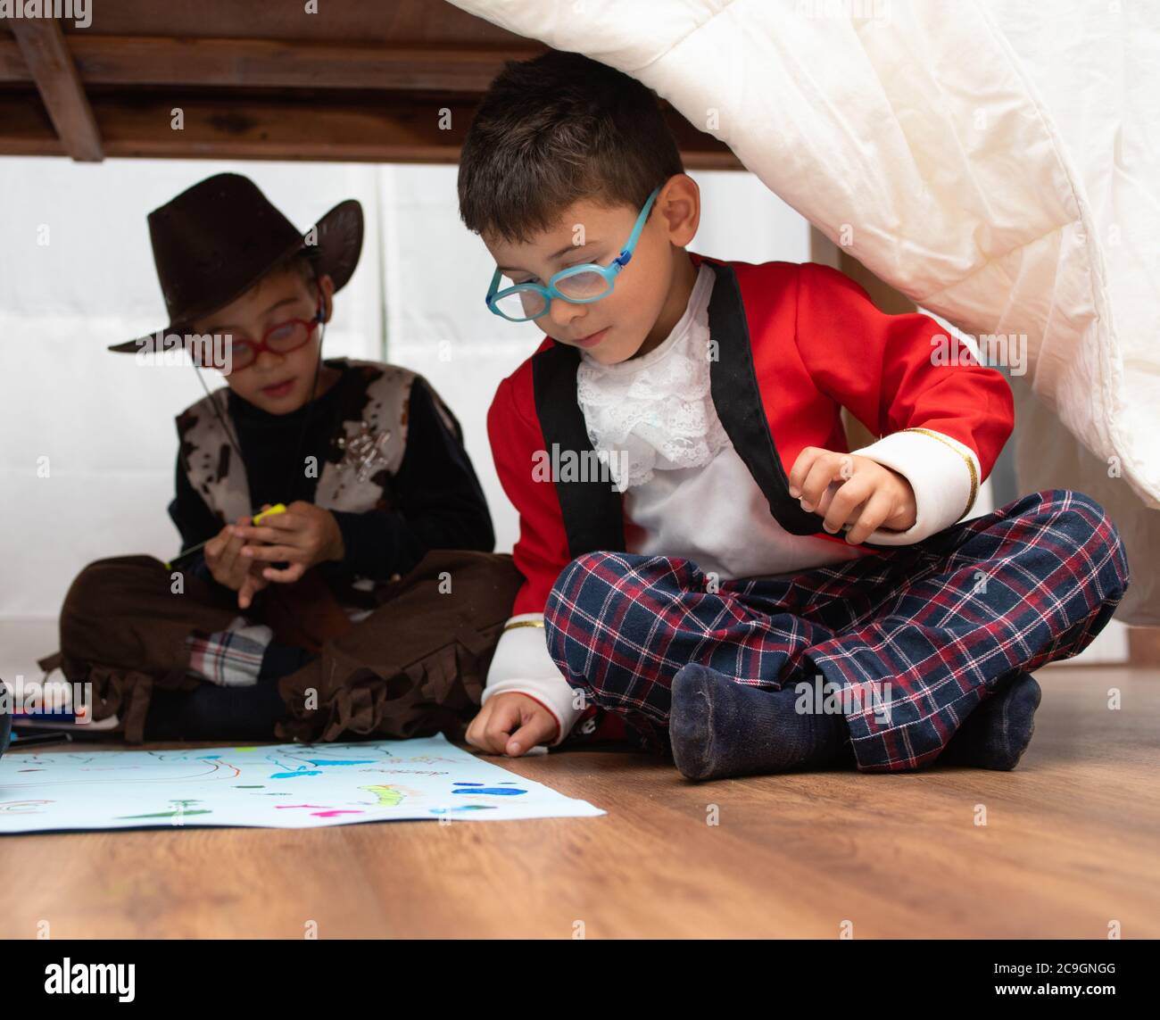 Closeup shot of kids playing together on the floor under a table Stock ...