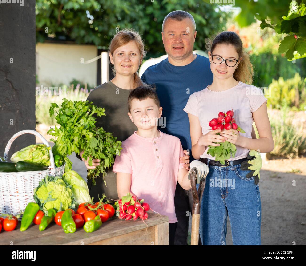 Portrait of friendly family with children in the backyard of country ...