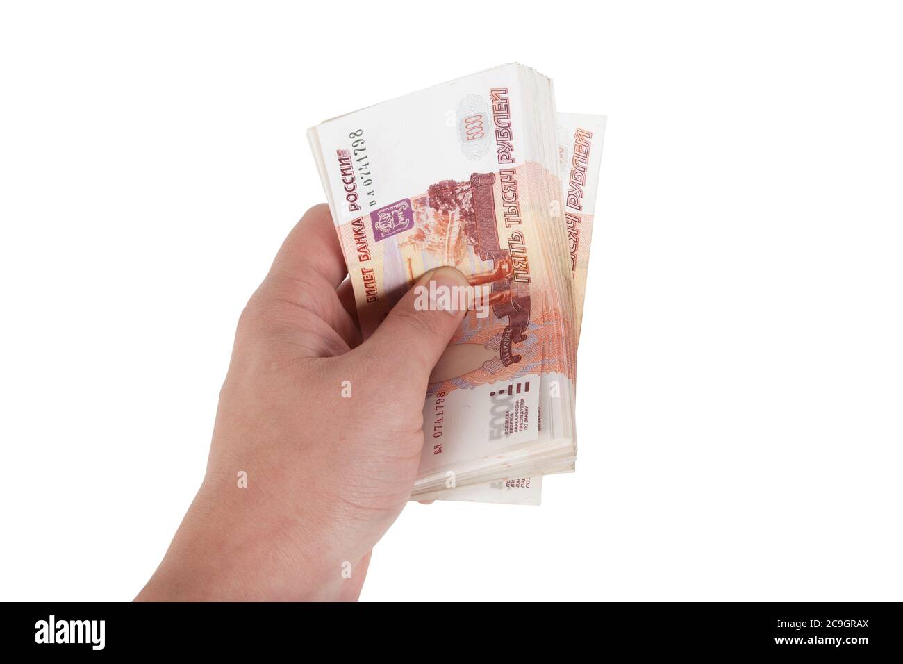 A bundle of banknotes of five thousand rubles in hand on a white ...