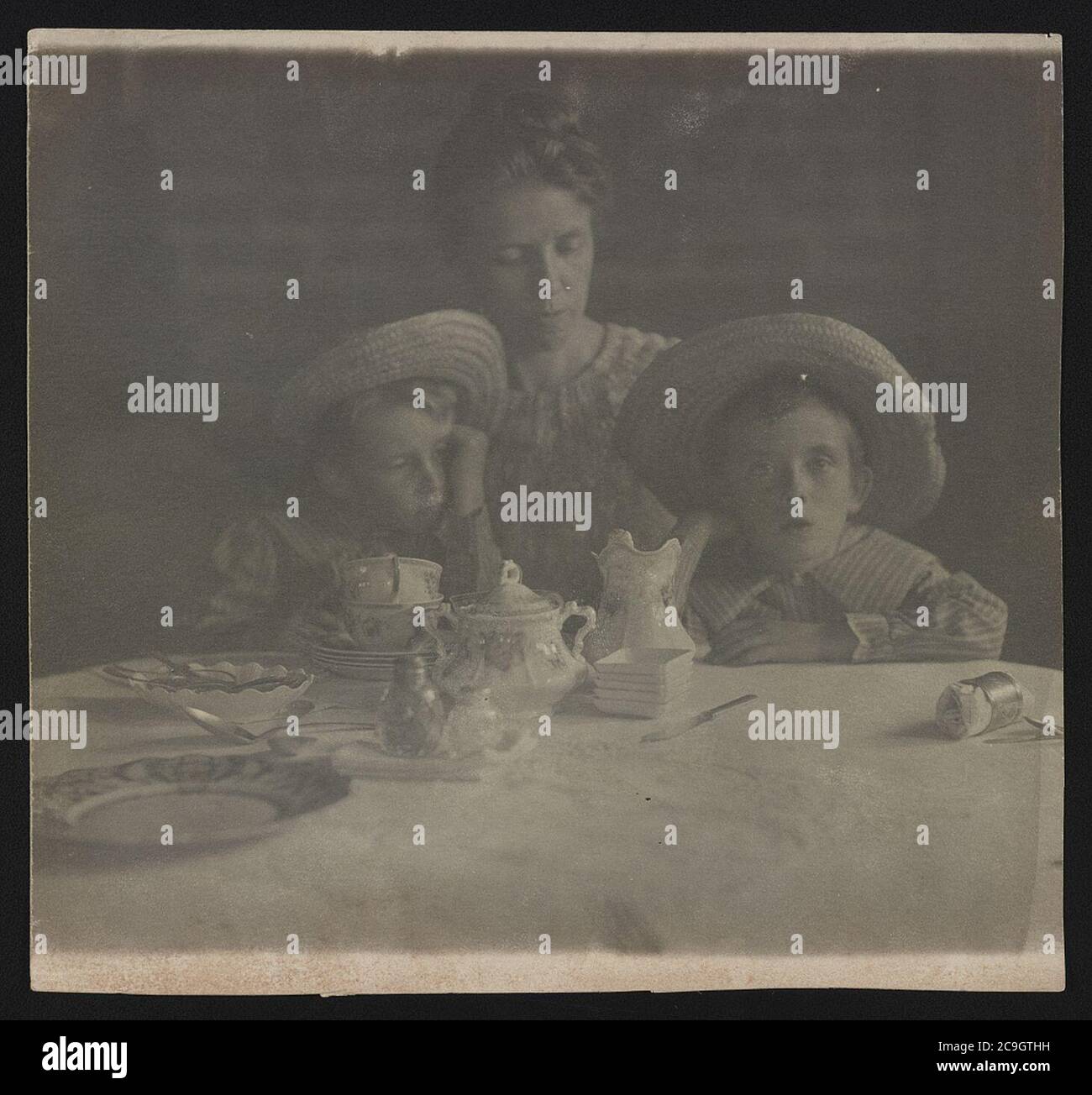 Jane White with sons Lewis and Maynard White seated at dining table ...