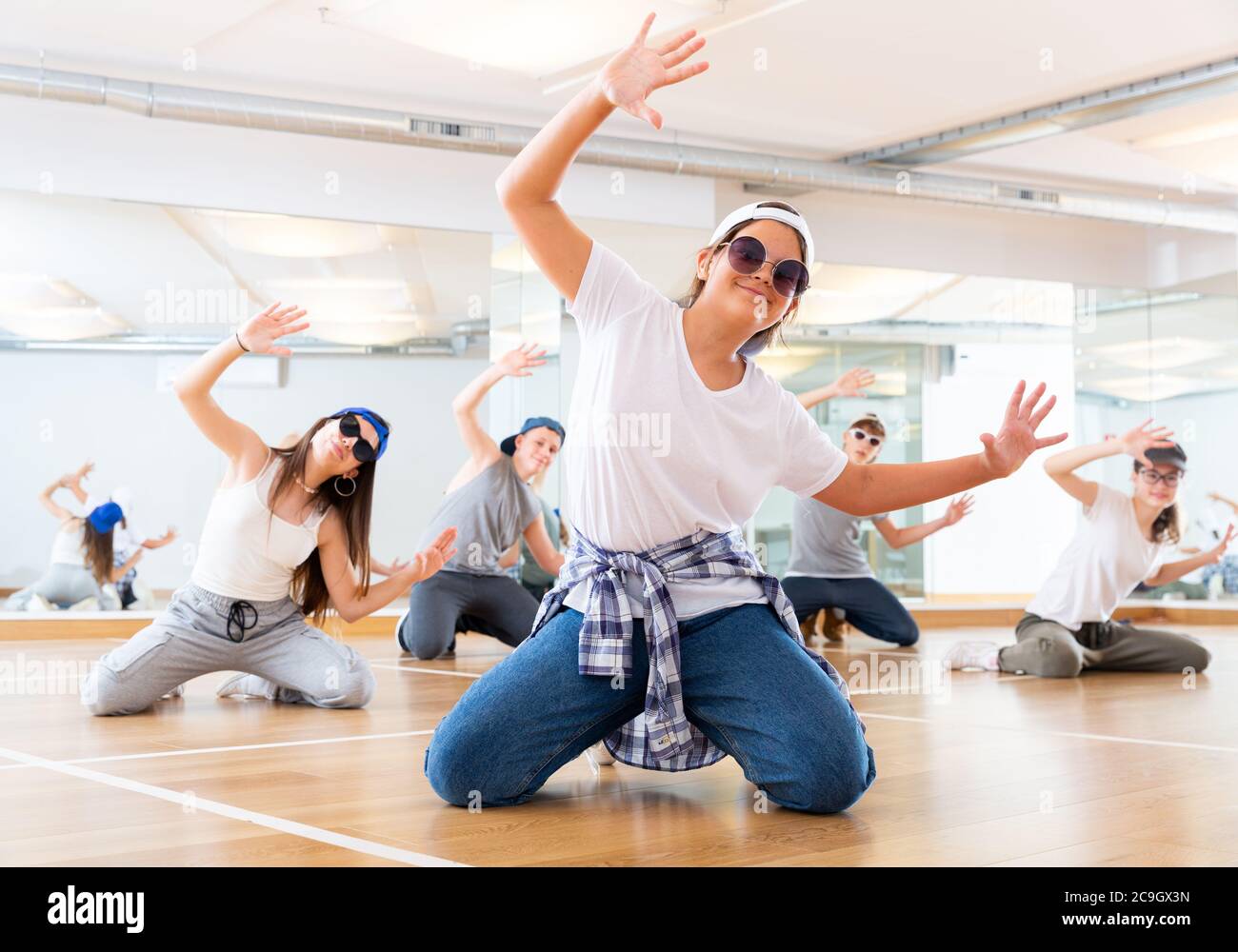 Portrait of emotional teenager girl doing hip hop movements during ...