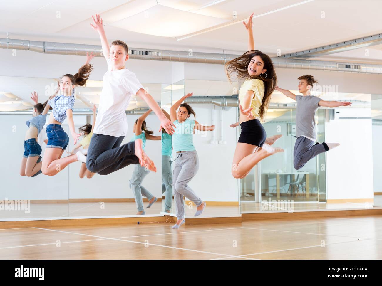 Group of young dancers jumping together in dance class Stock Photo - Alamy