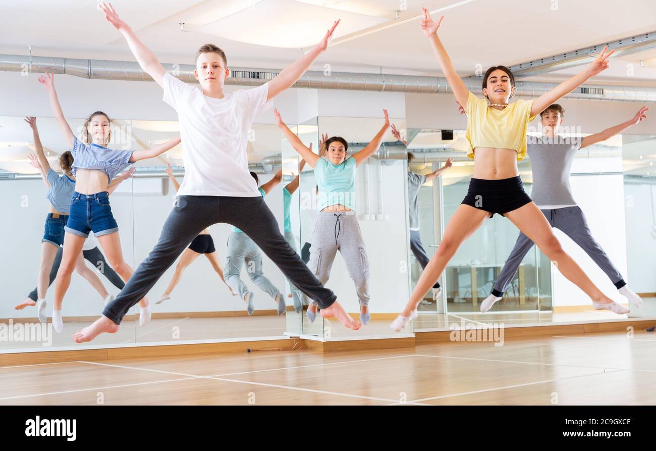 Group of young dancers jumping together in dance class Stock Photo - Alamy