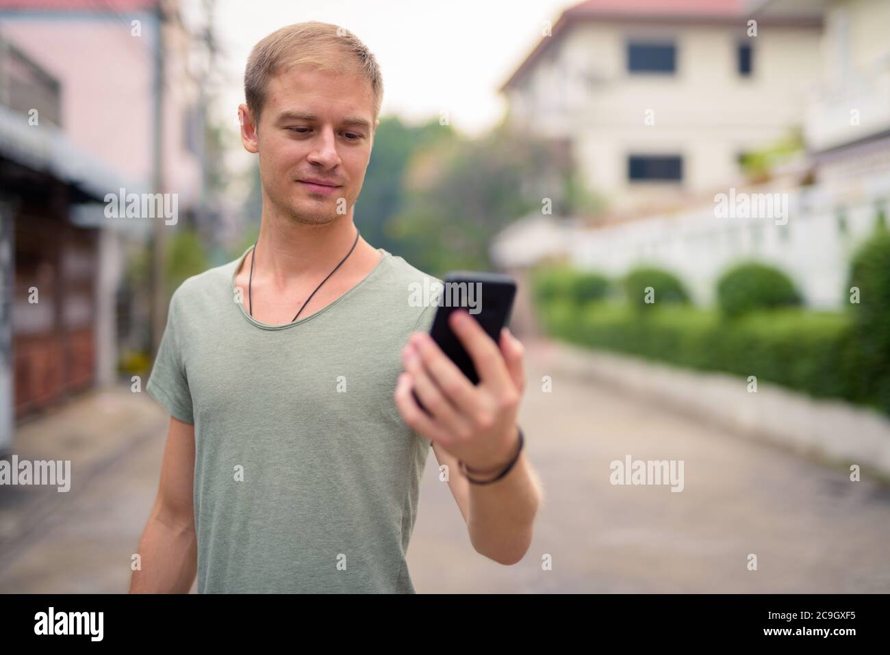 Handsome tourist man in the streets outdoors Stock Photo - Alamy