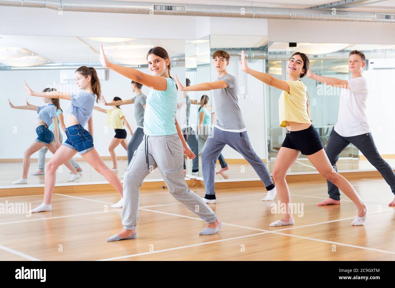 Dancing group of five teenagers practicing new dance in studio Stock ...