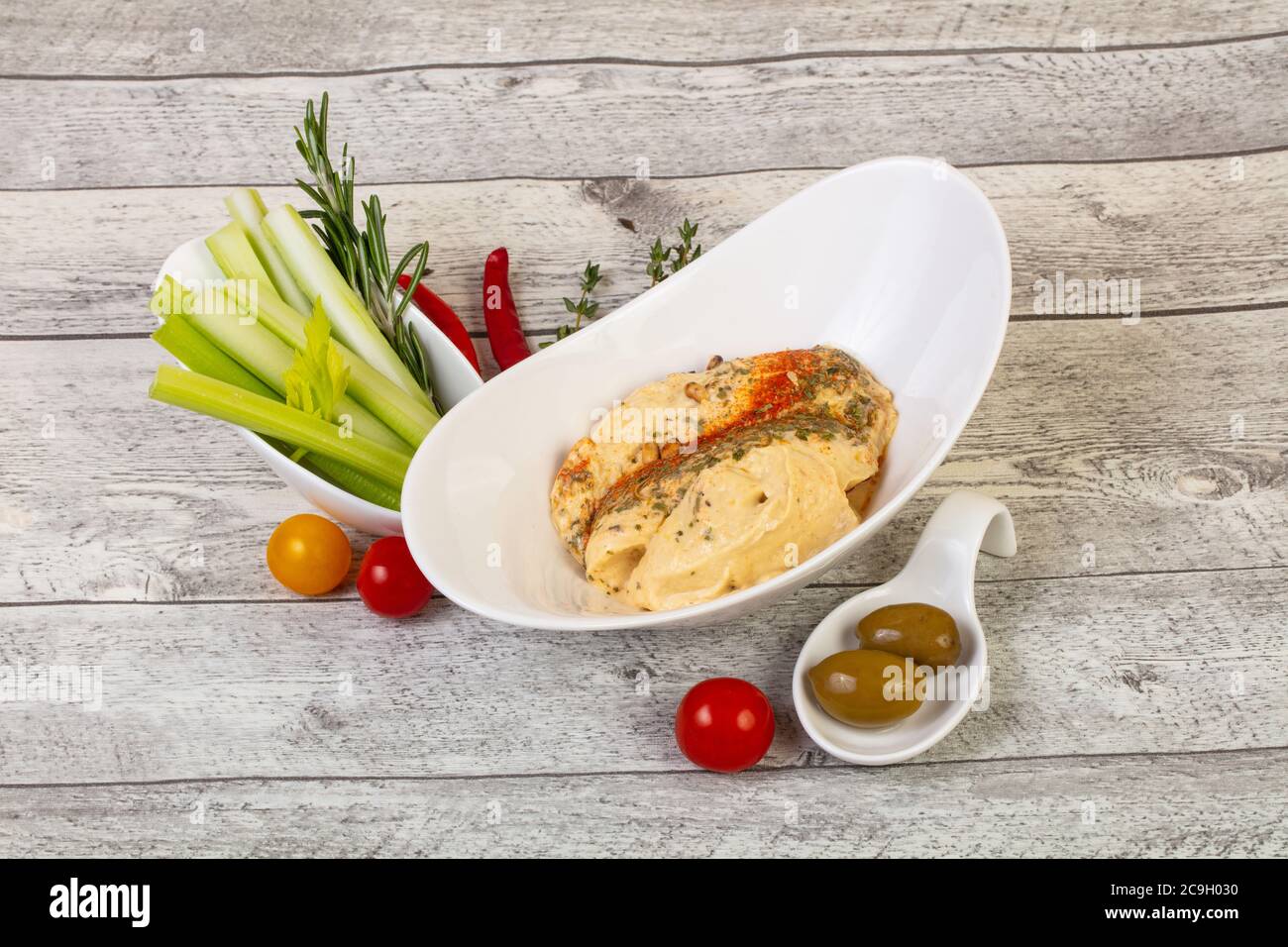 Vegan cuisine - Humus with celery sticks Stock Photo - Alamy