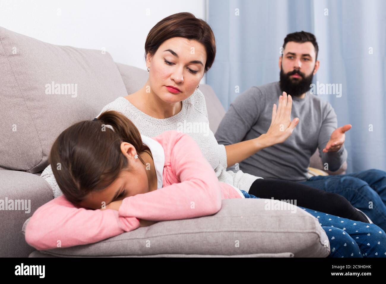 Father telling off his wife and daughter for disobedience at home Stock ...