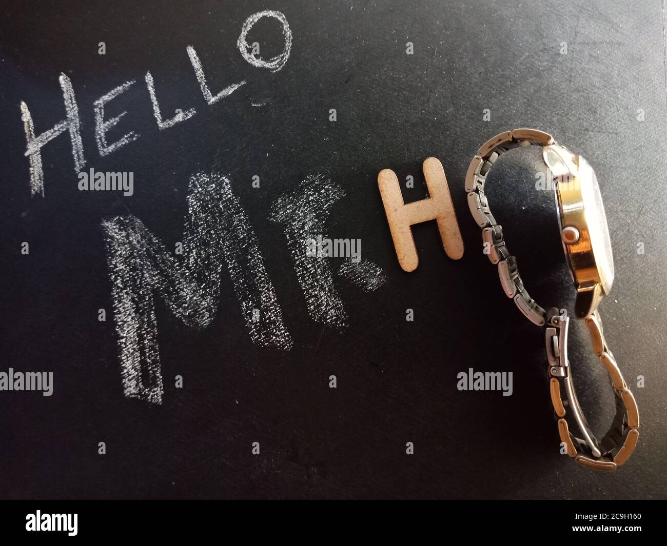 Hello mister H text displayed on chalk board concept with wooden ...