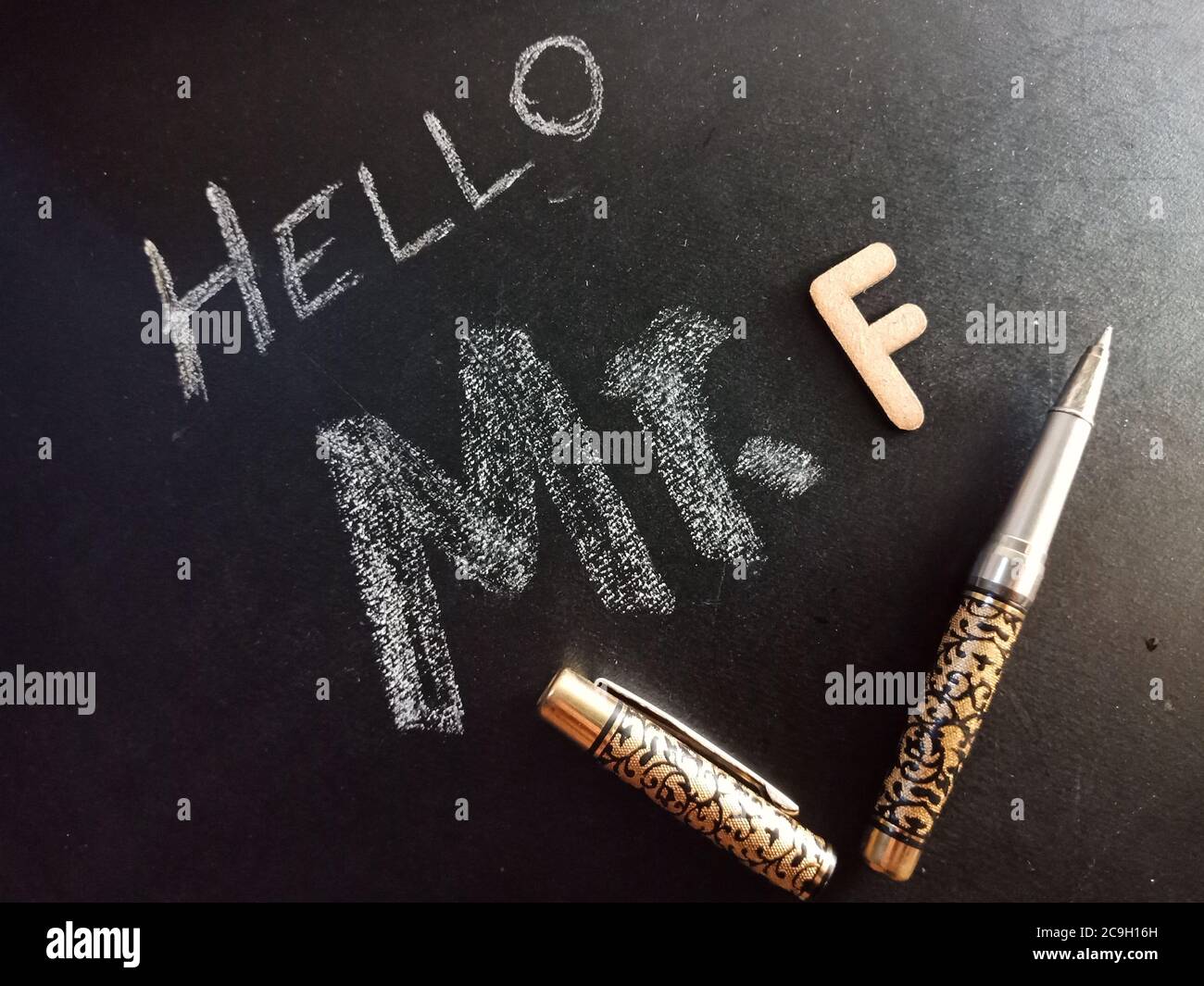 Hello mister F text displayed on chalk board concept with wooden ...