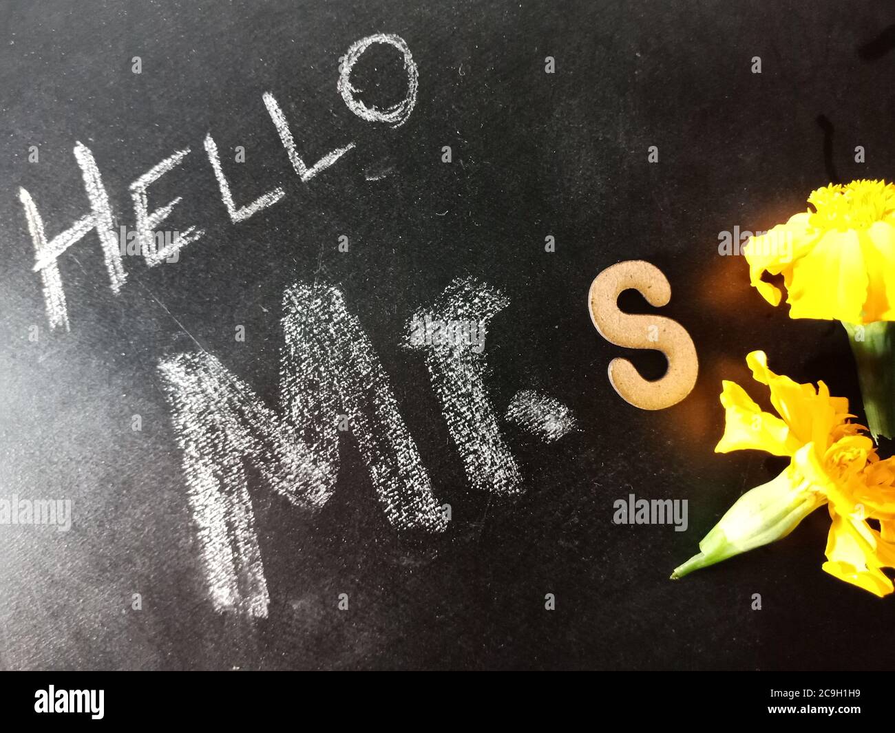 Hello mister S text displayed on chalk board concept with wooden ...