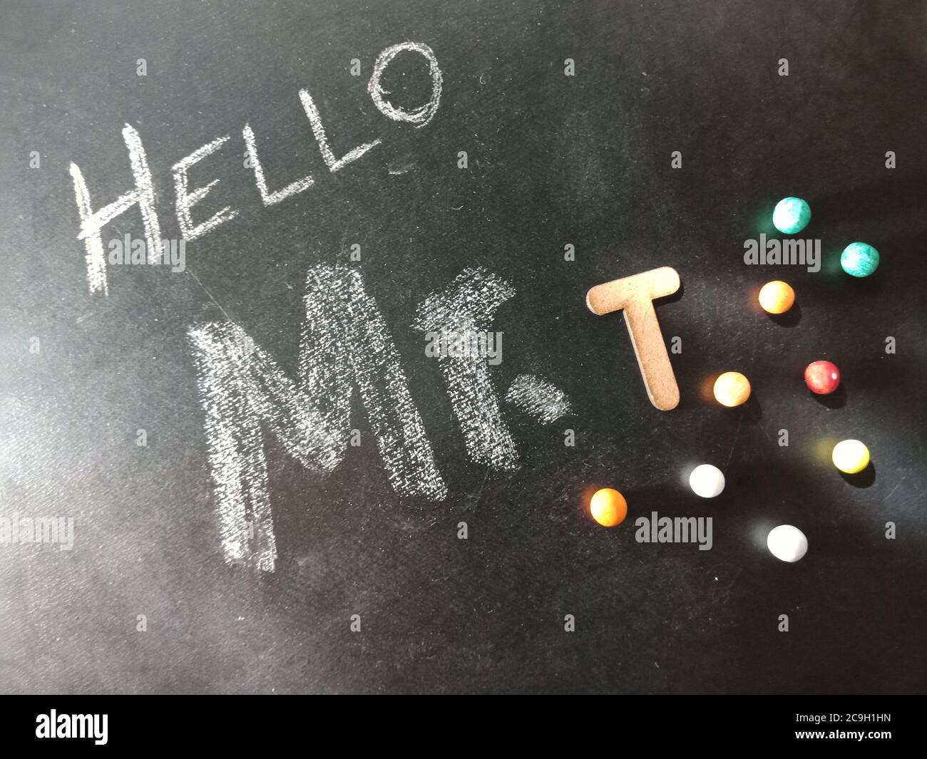 Hello mister T text displayed on chalk board concept with wooden ...