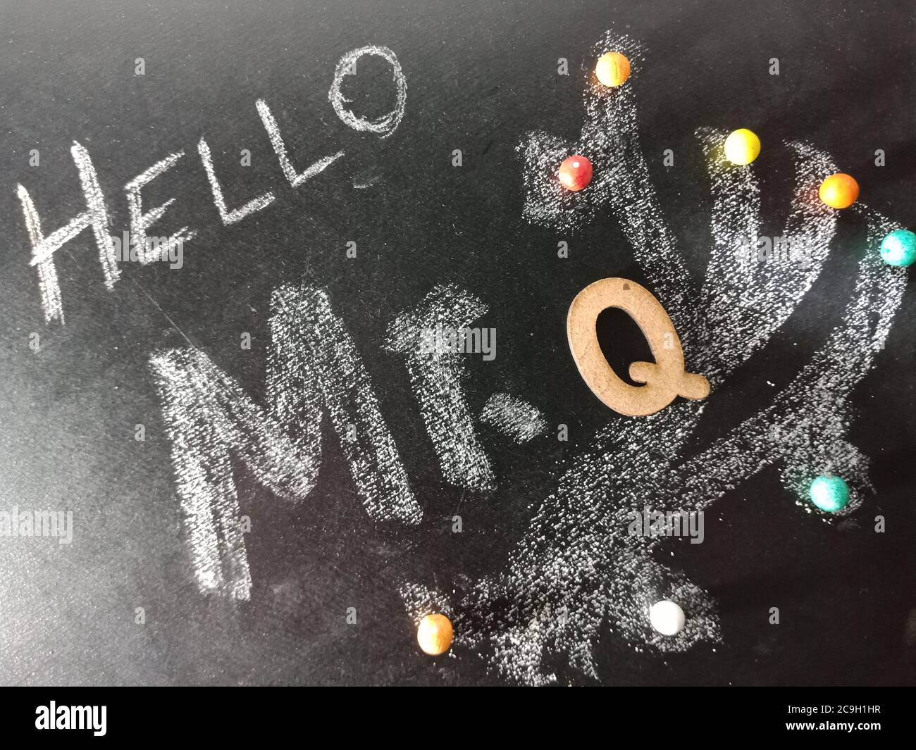 Hello mister Q text displayed on chalk board concept with wooden ...
