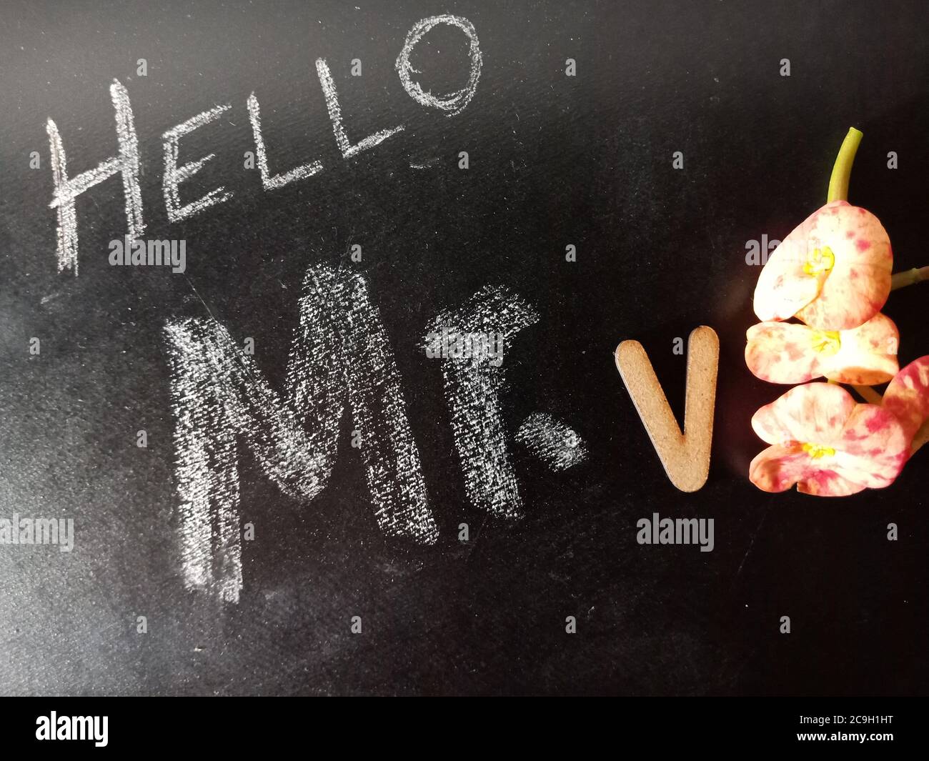 Hello mister V text displayed on chalk board concept with wooden ...