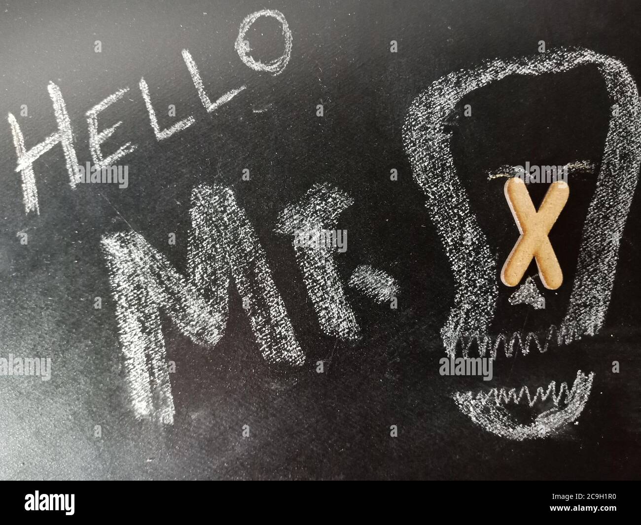 Hello mister X text displayed on chalk board concept with wooden ...