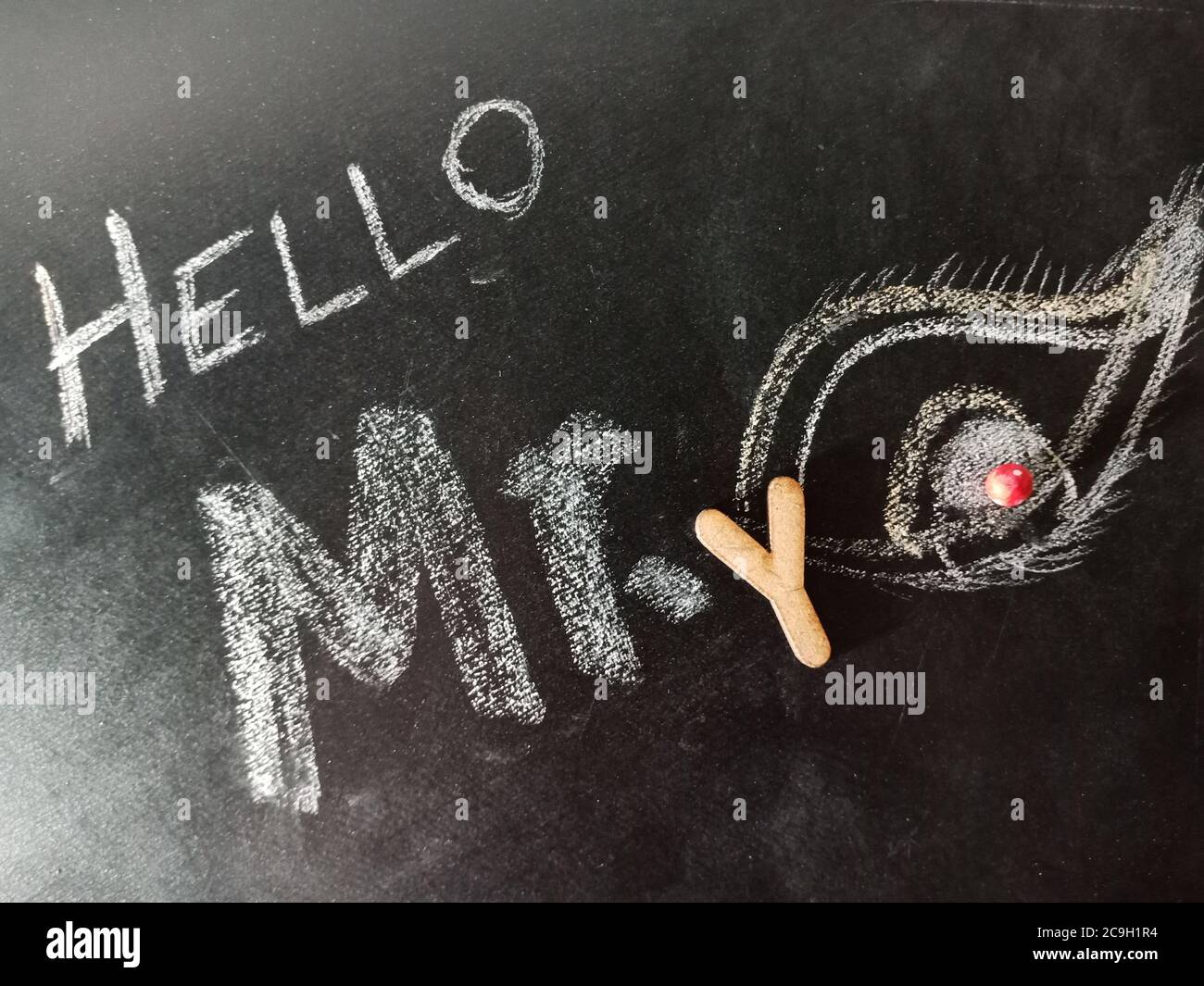 Hello mister Y text displayed on chalk board concept with wooden ...