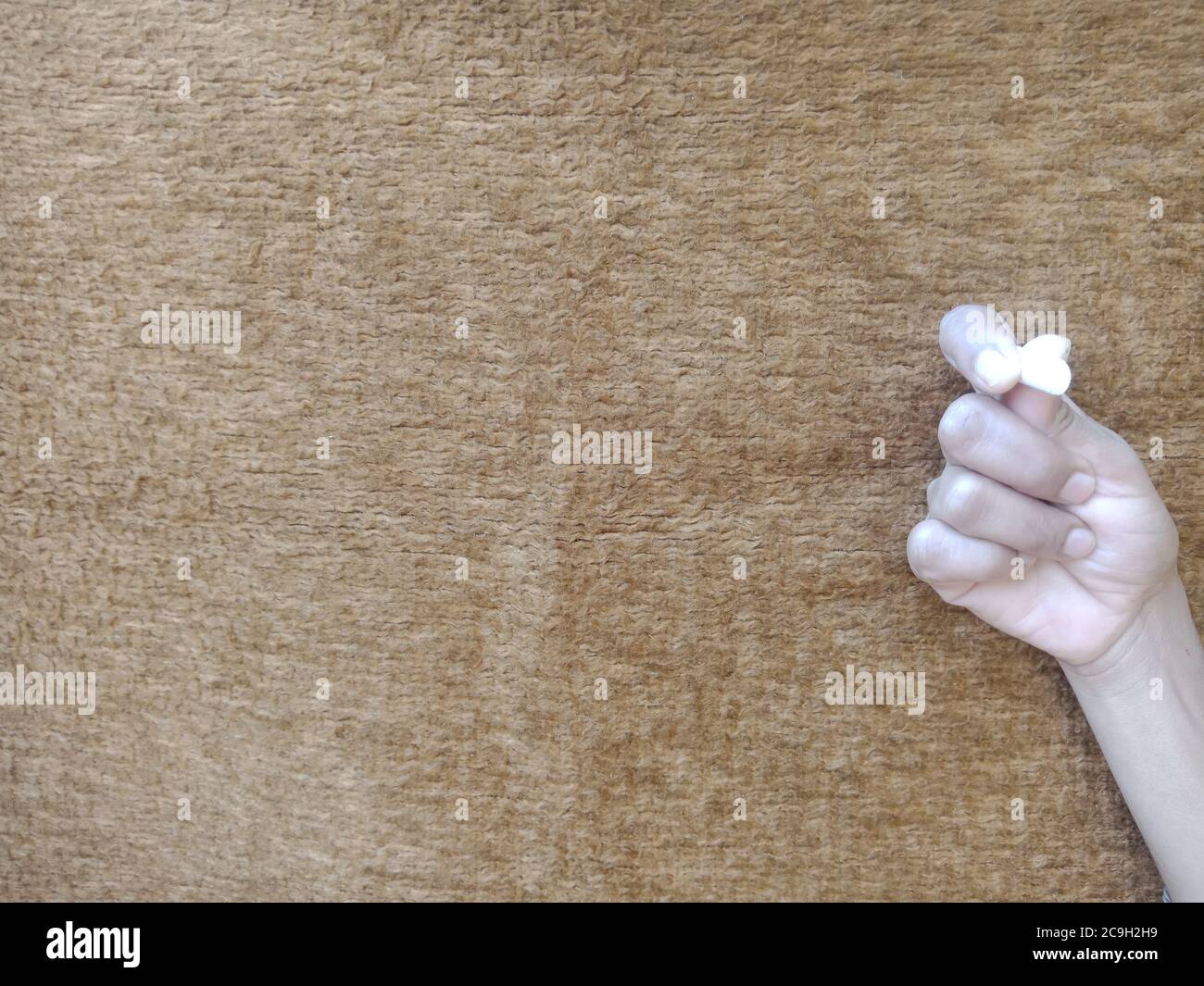 Writing hand isolated on brown background for education business style ...