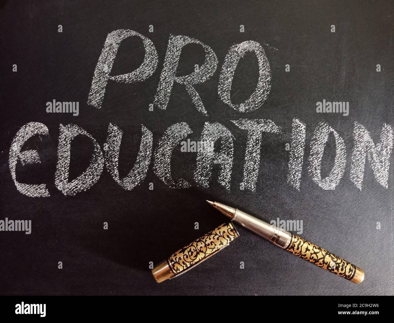 Pro education word presented on chalkboard with school educational ...