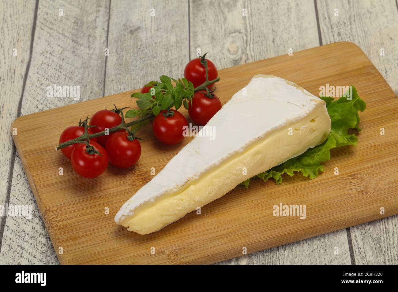 Brie cheese triangle served salad leaves Stock Photo - Alamy
