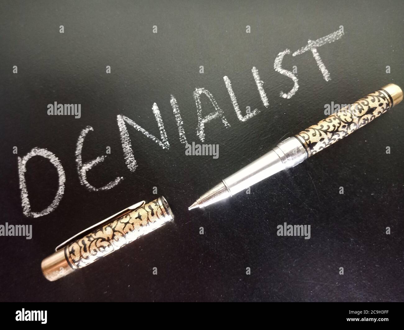 Denialist word presented on chalkboard with school educational ...