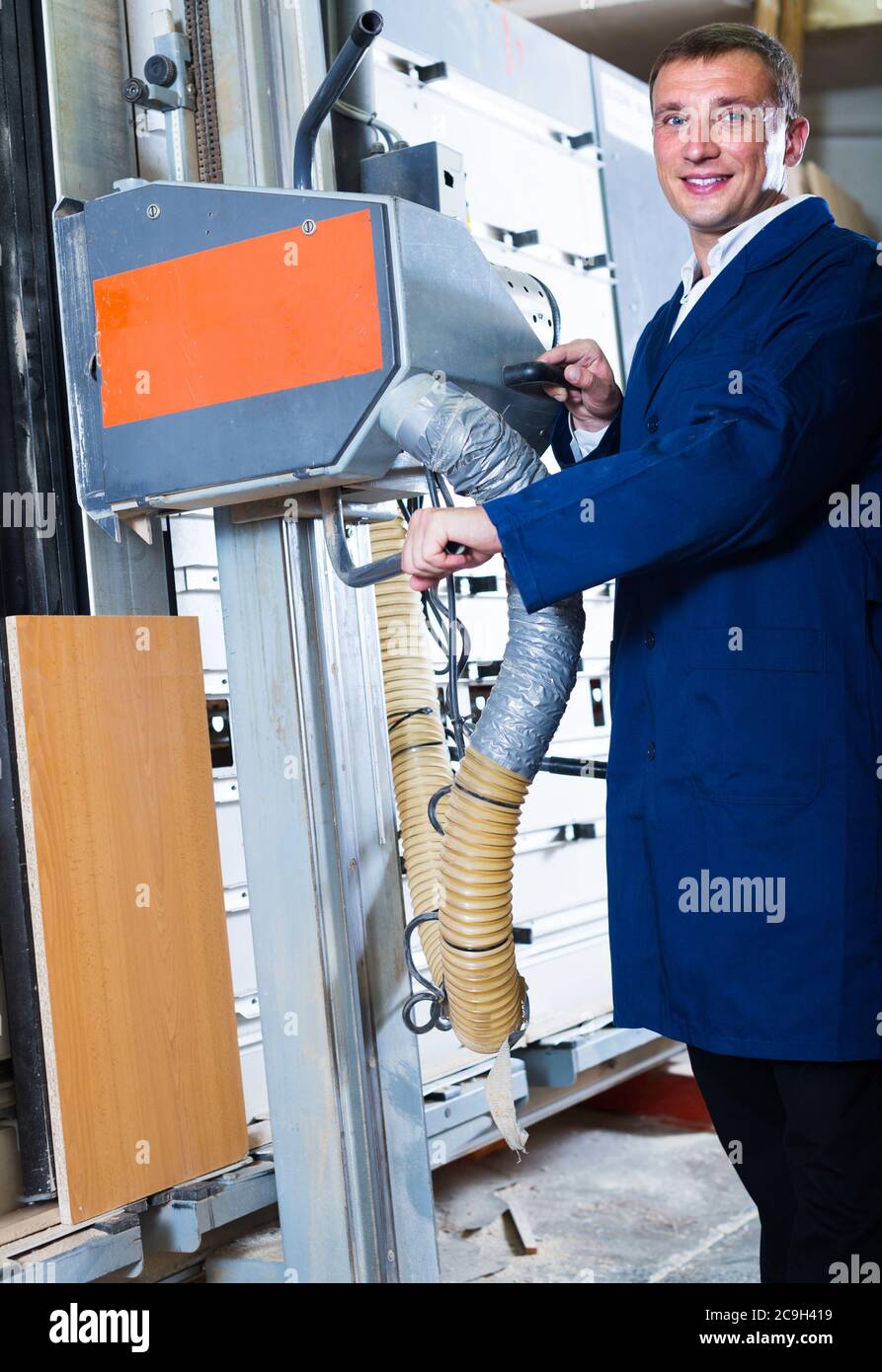 workman operating large automatic saw machinery Stock Photo - Alamy