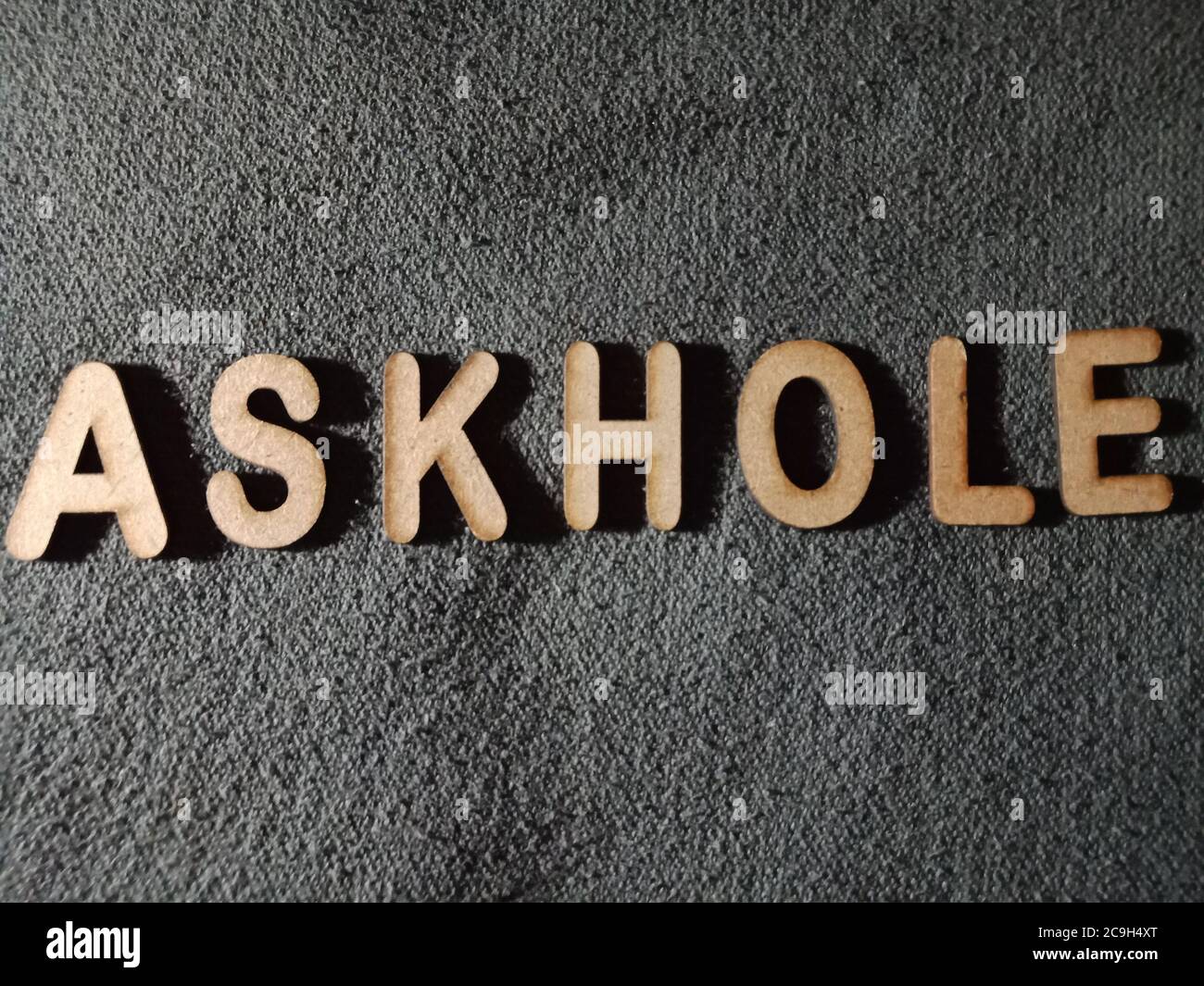 Askhole latest vocabulary presented on grey texture with wooden ...