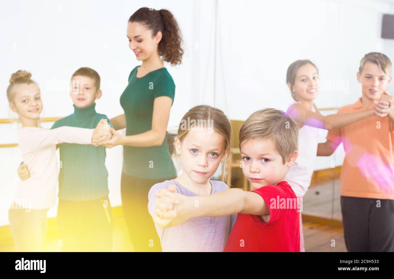 Group of caucasian children dancing tango in dance studio Stock Photo ...