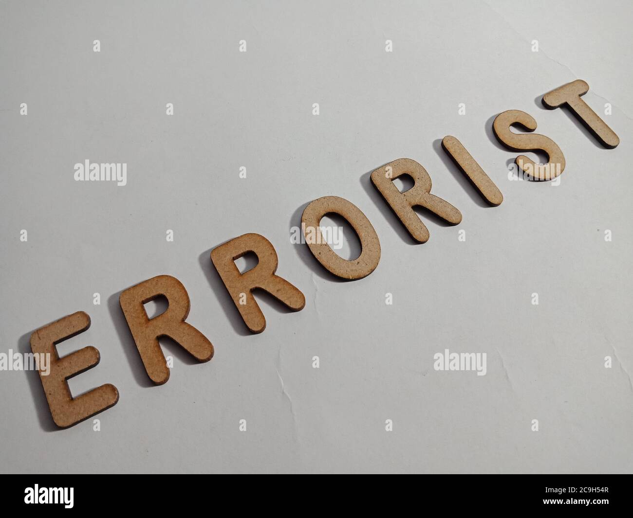 Errorist latest vocabulary presented on white paper texture with wooden ...