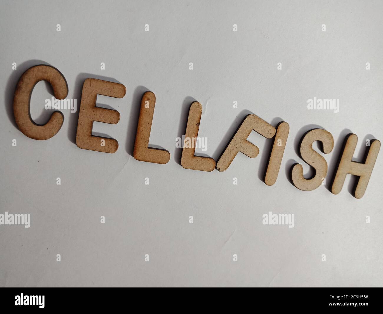 Cellfish latest vocabulary presented on white paper texture with wooden ...