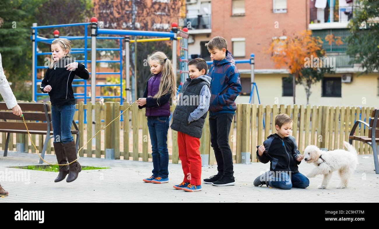 positive russian children playing rubber band jumping game and laughing ...