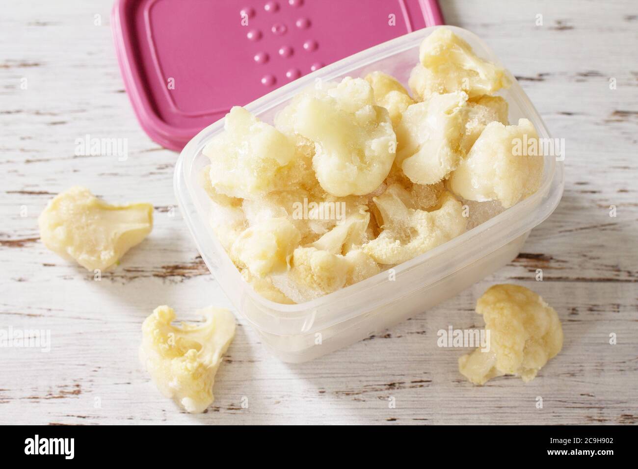 Healthy frozen food for the winter. Containers with frozen cauliflower ...