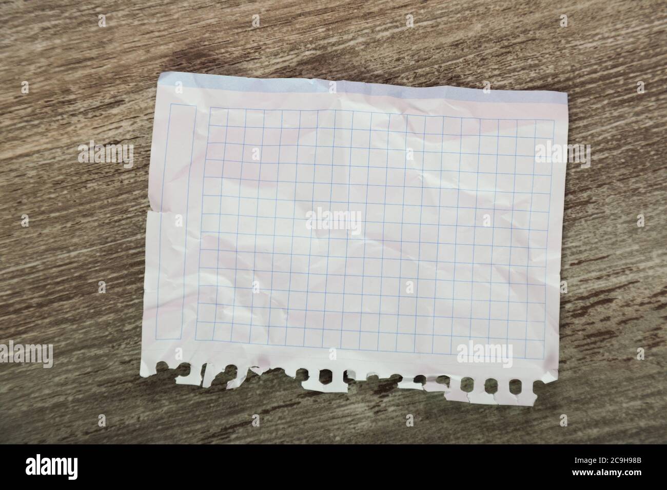 Torn-off sheet of notebook on table Stock Photo - Alamy