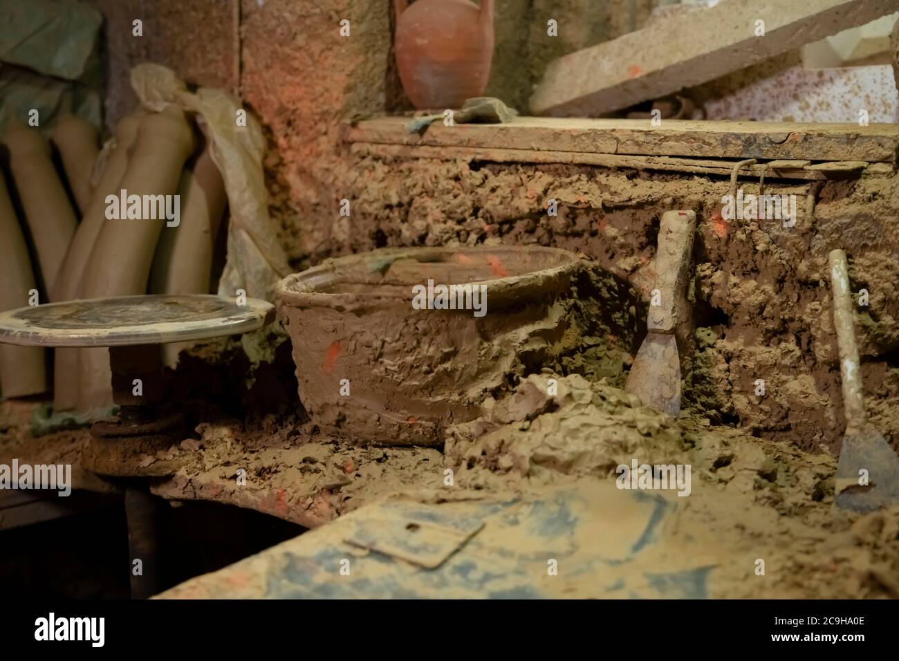 Set of dirty art and craft sculpting tools on wooden table in pottery ...