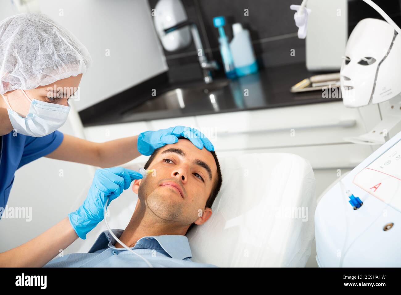 Young man client getting carboxy therapy on face skin, cosmetology ...