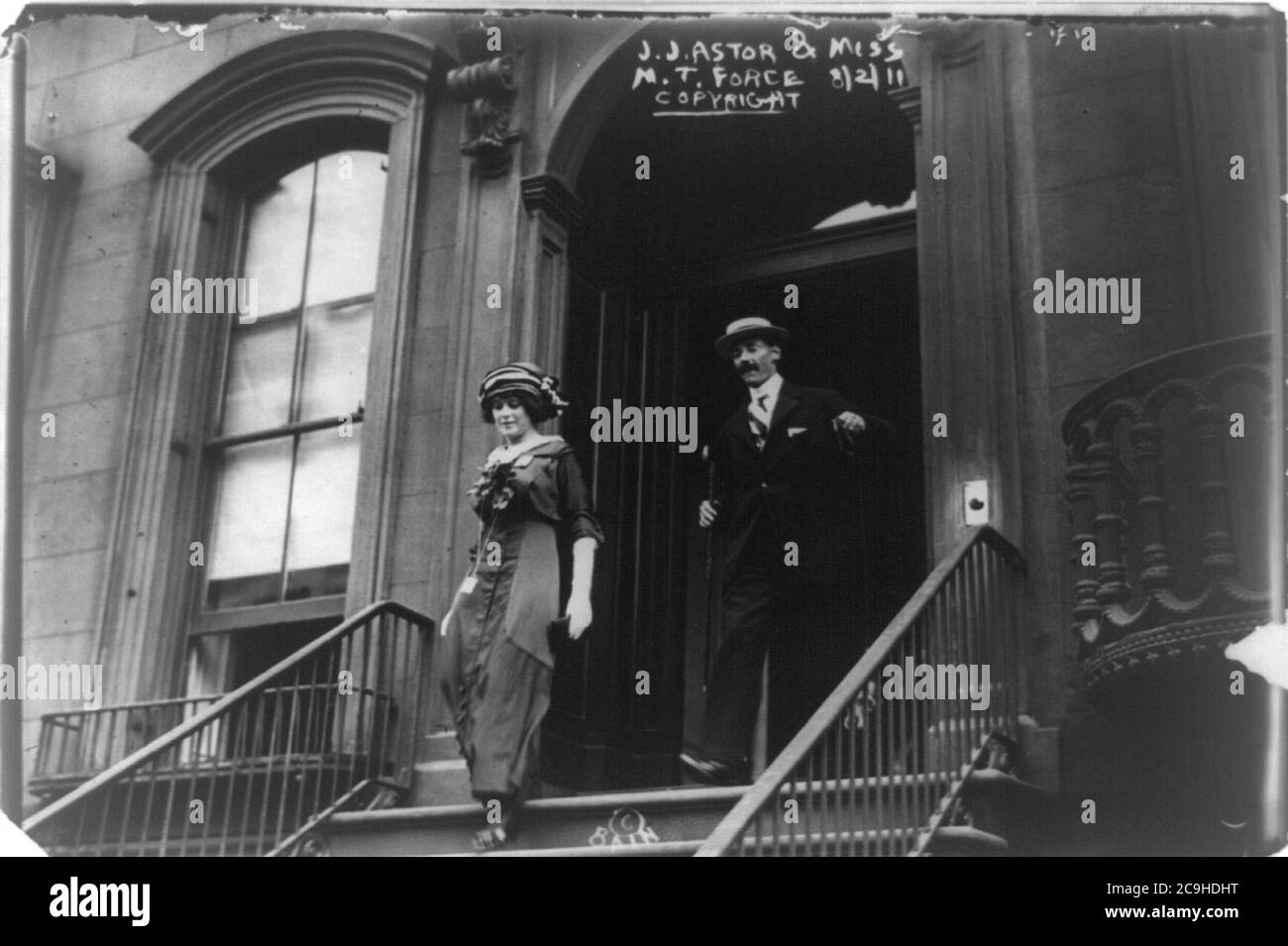 J.J. Astor and Miss M.T. Force walking down steps outside building ...