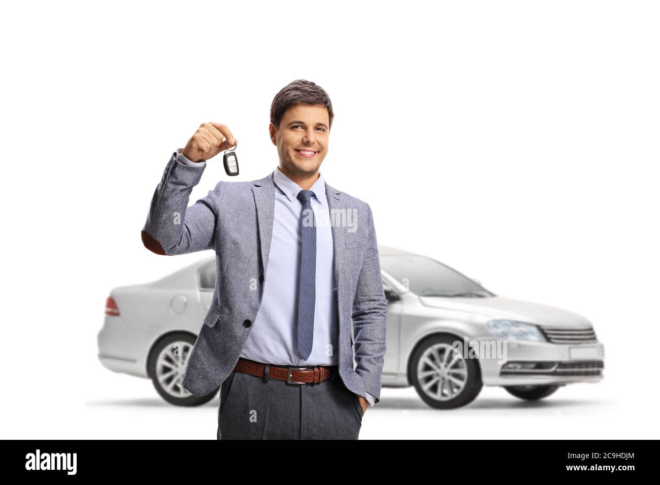 Happy man buying a new silver car and holding keys isolated on white ...