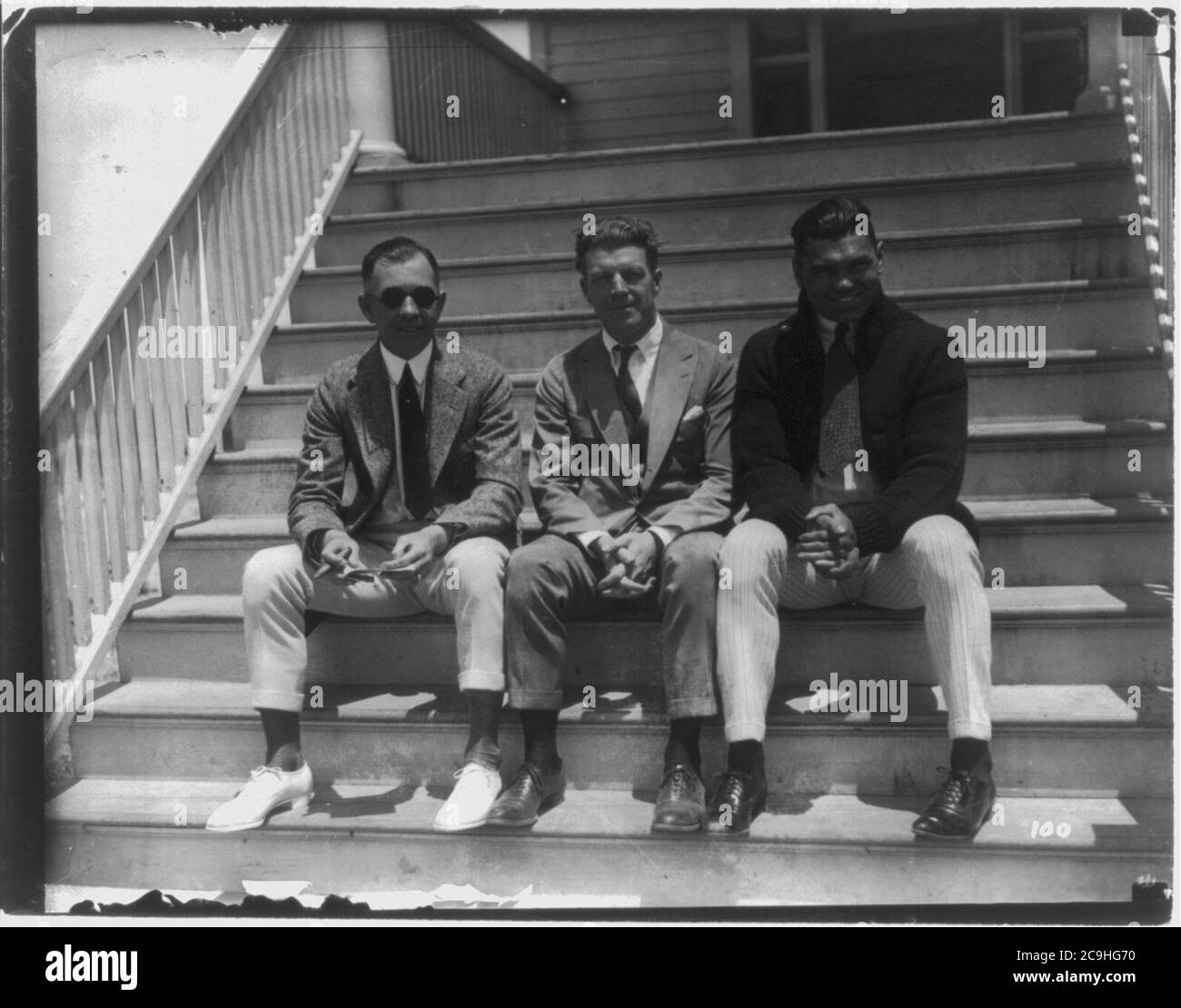 Jack Dempsey at his training camp, June 1921- seated on porch steps ...
