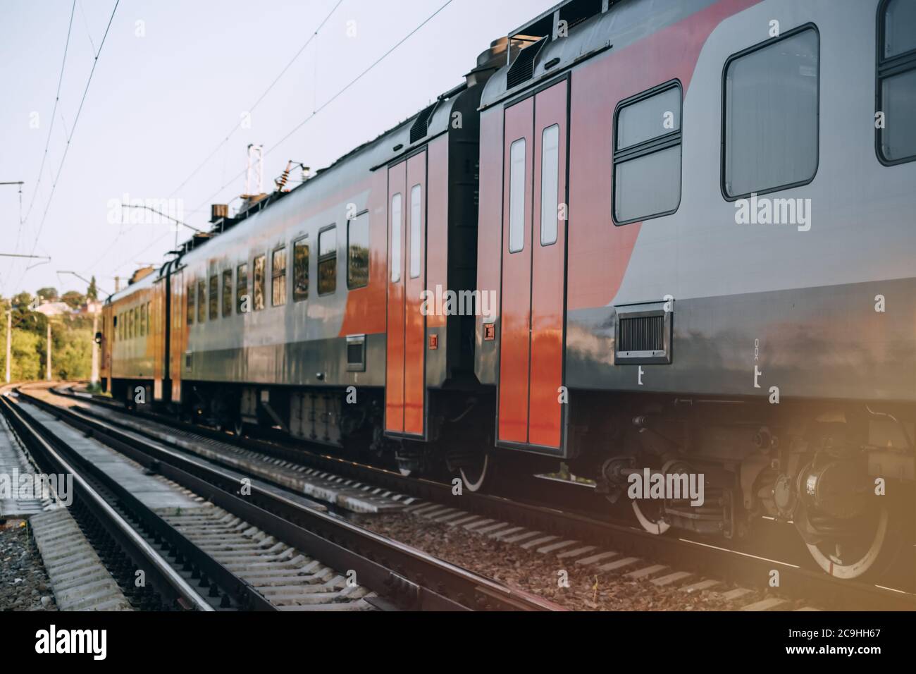 Passenger electric train moving on the railway Stock Photo - Alamy