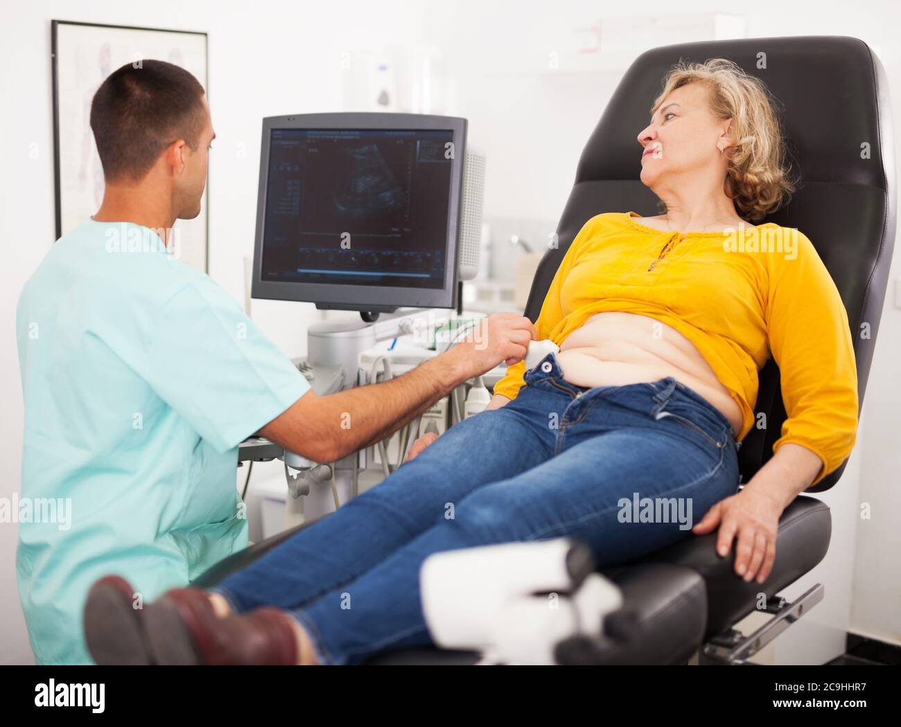Man doctor examination a elderly woman at abdomen with ultrasonography ...