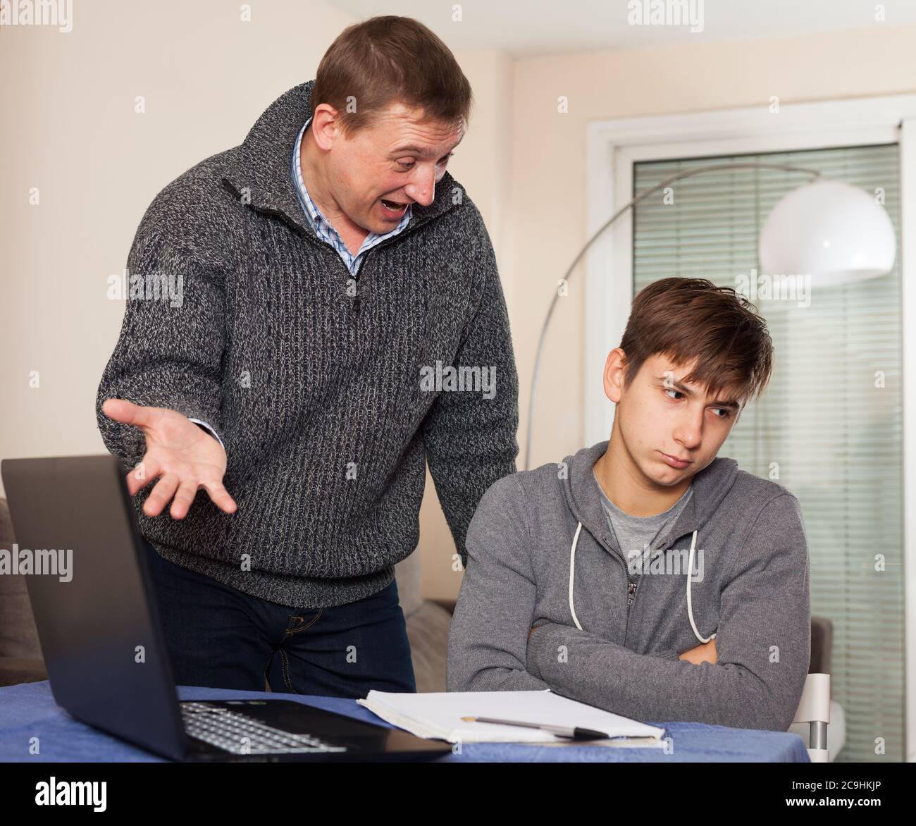 Father unhappy with how teenage son learns Stock Photo - Alamy