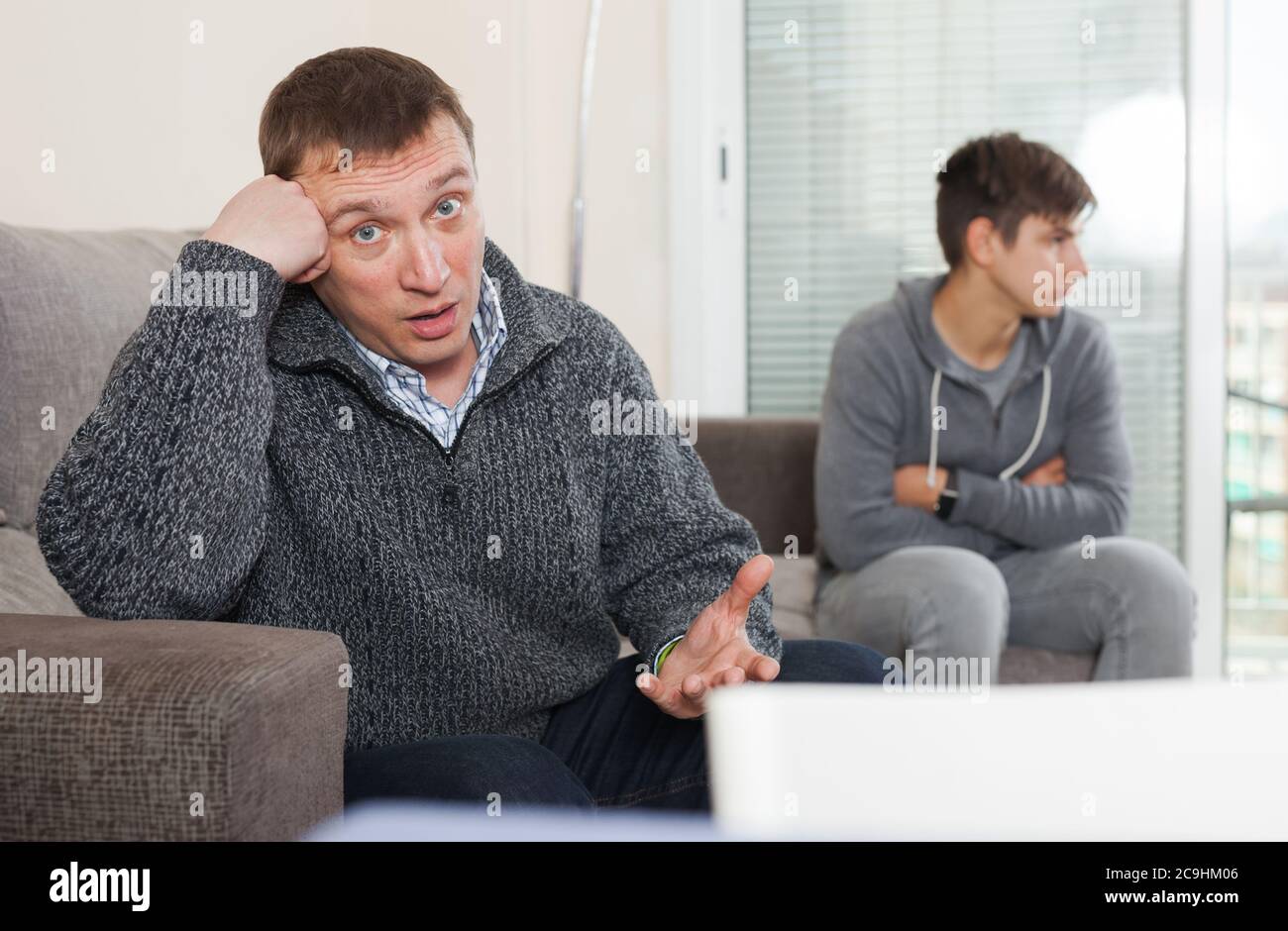 Outraged father unhappy with his son teenager Stock Photo - Alamy