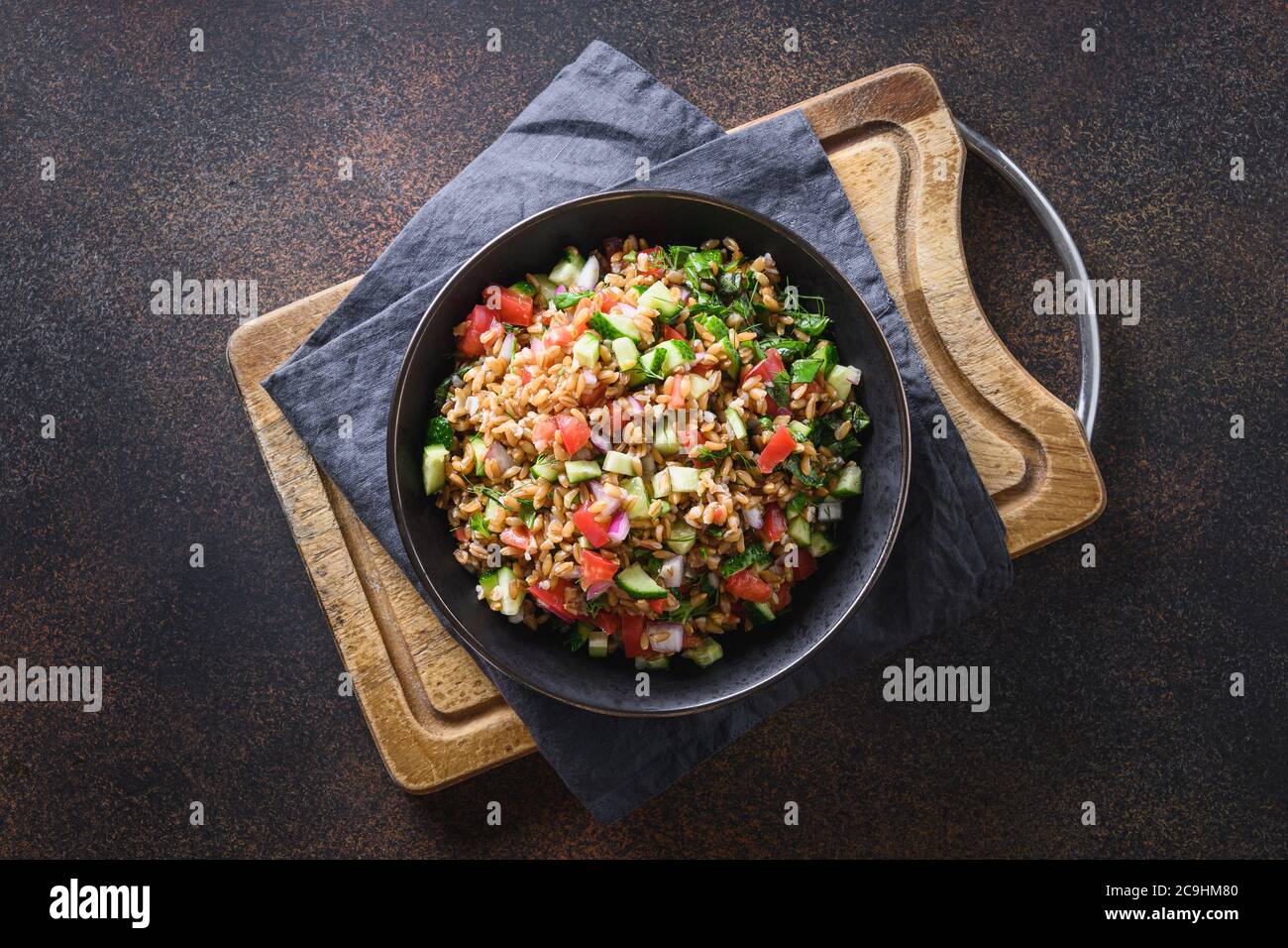 Cooked Whole Grain cereal spelt salad with seasonal vegetables in bowl ...