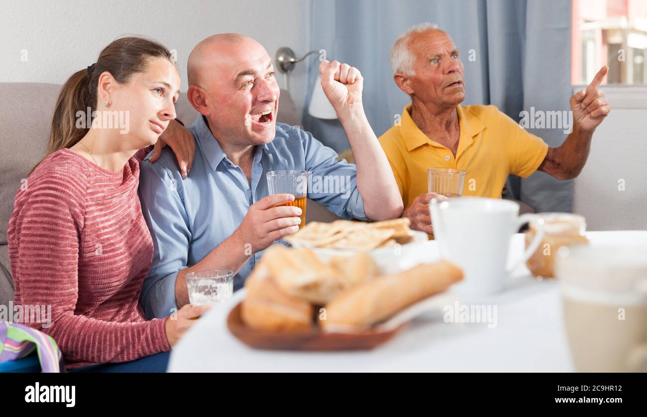 Family three emotionally watching hi-res stock photography and images ...